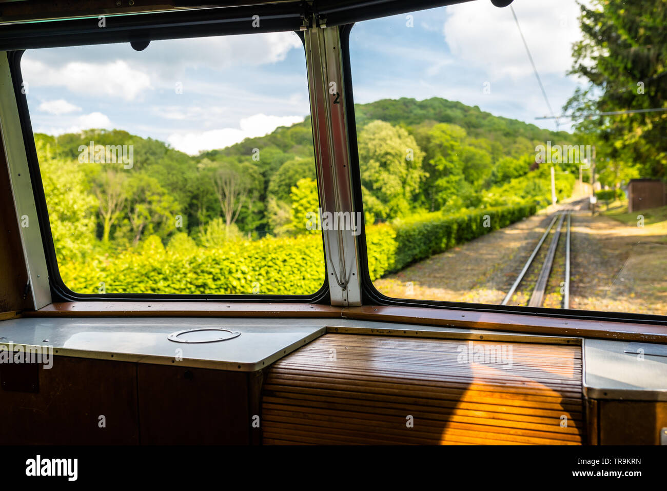 A view from the window of a moving train, visible tracks, trees and ...