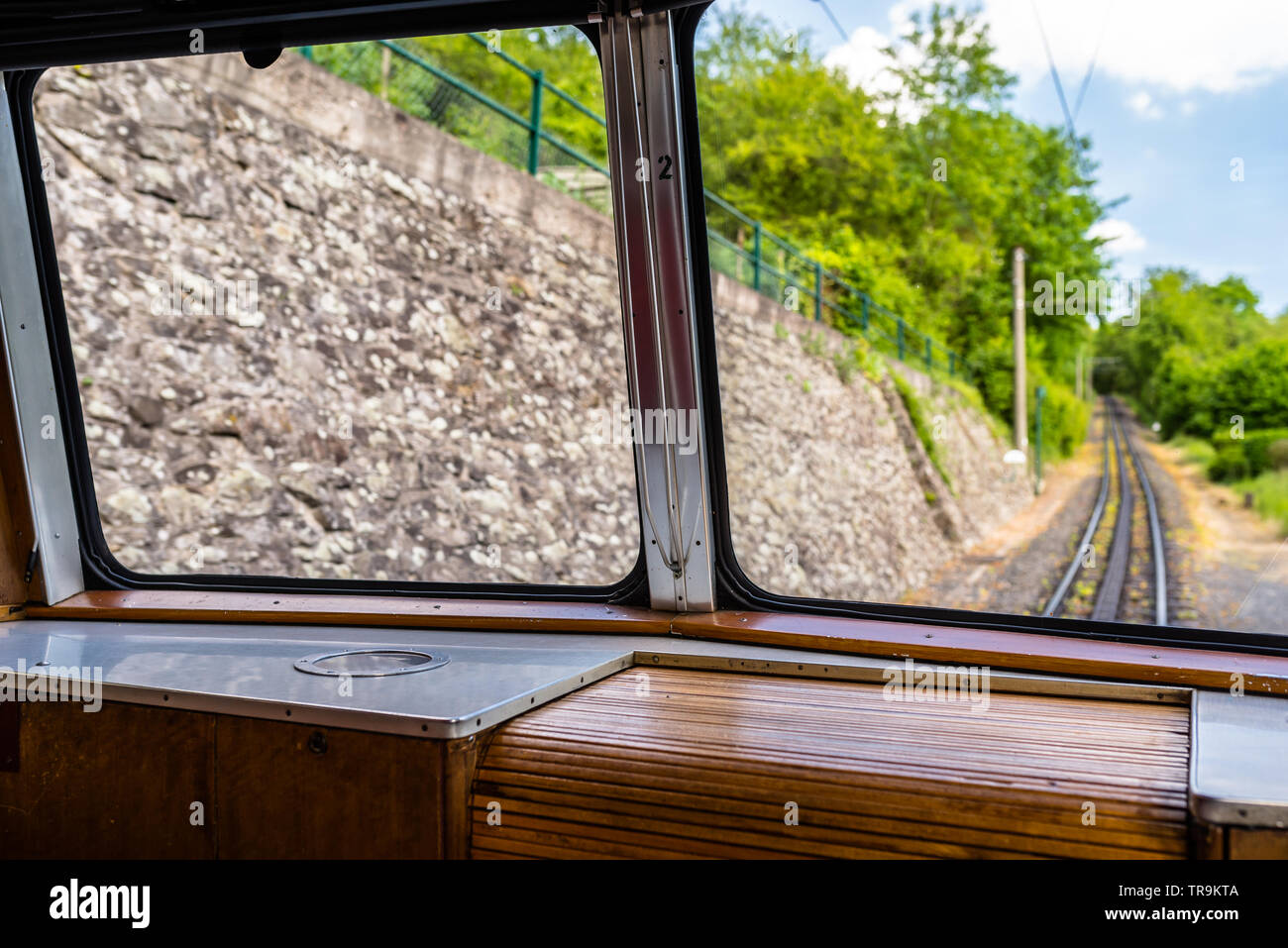 A view from the window of a moving train, visible tracks, trees and ...