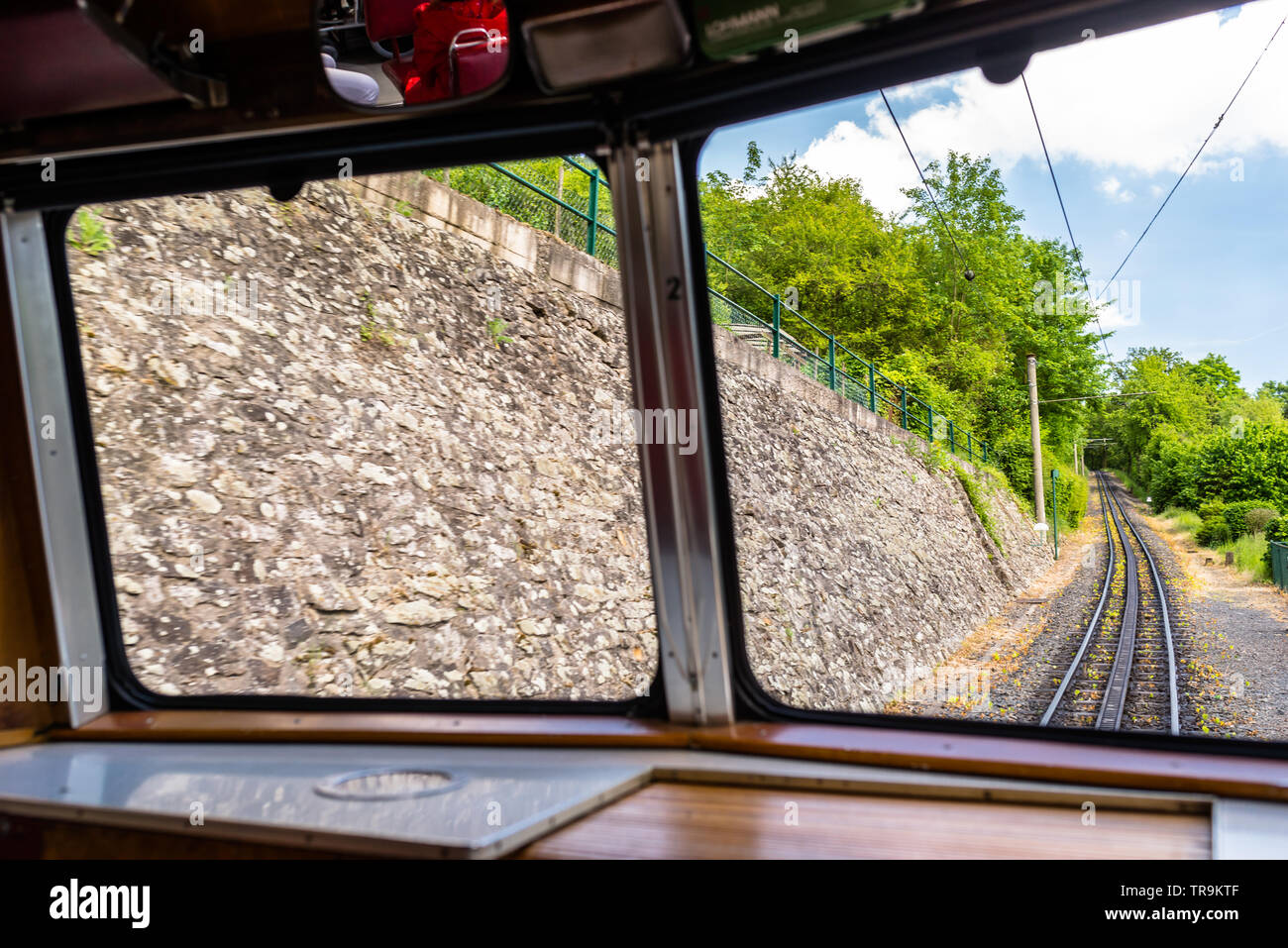 A view from the window of a moving train, visible tracks, trees and ...