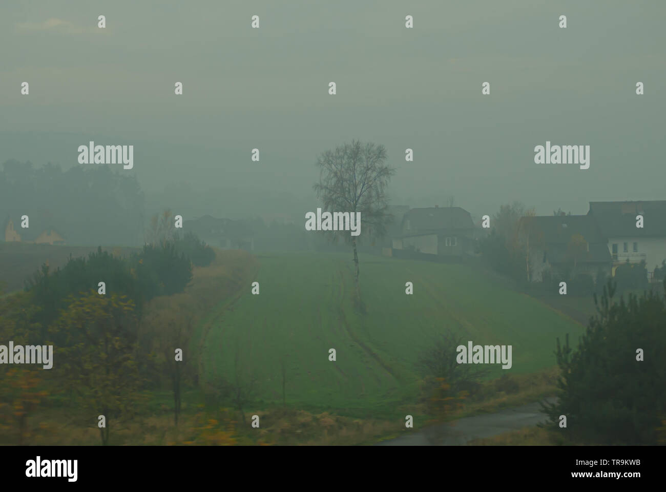 Foggy view of a rural small town and fields Stock Photo - Alamy