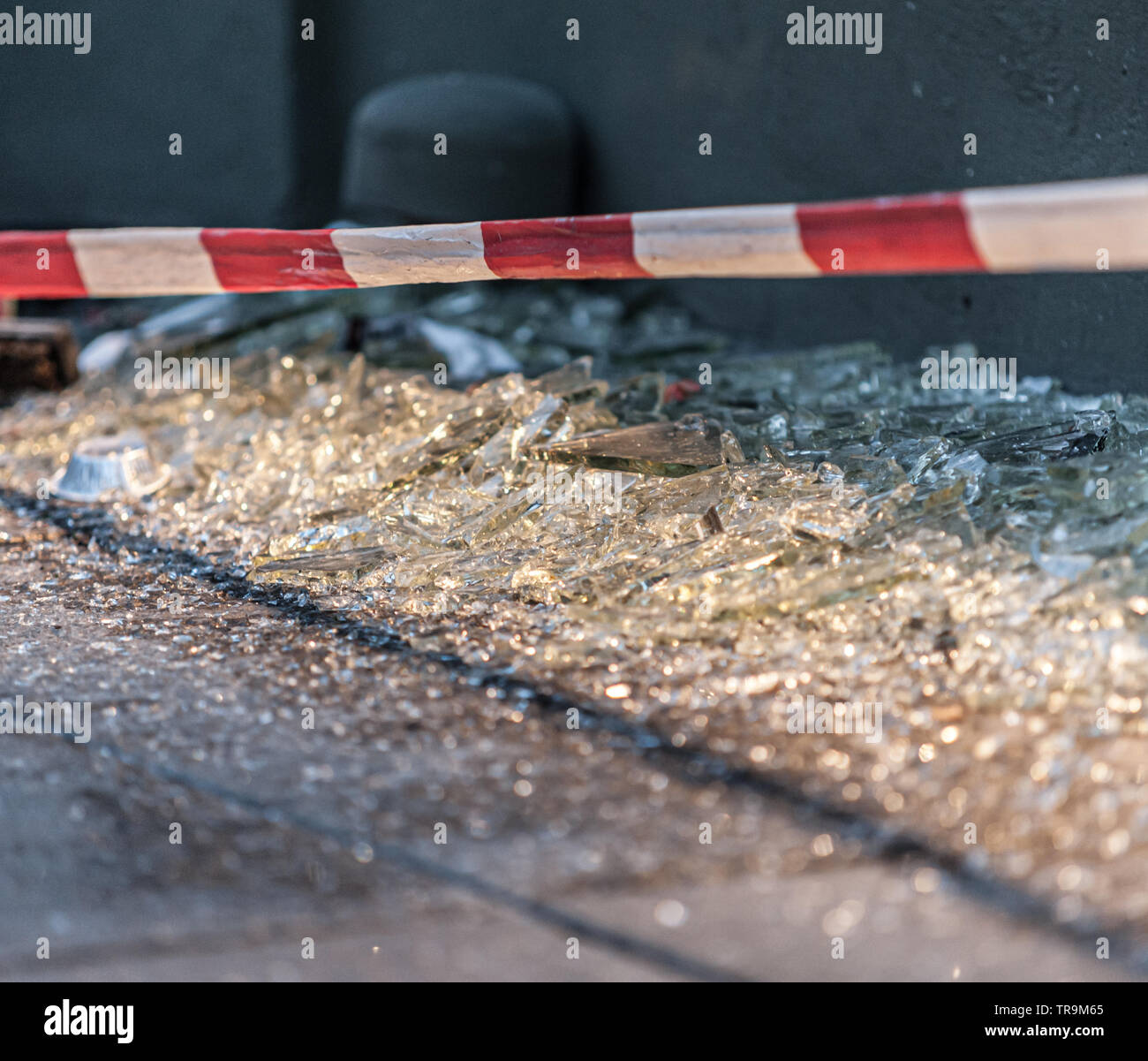 Broken glass on the ground and a barricade tape Stock Photo - Alamy