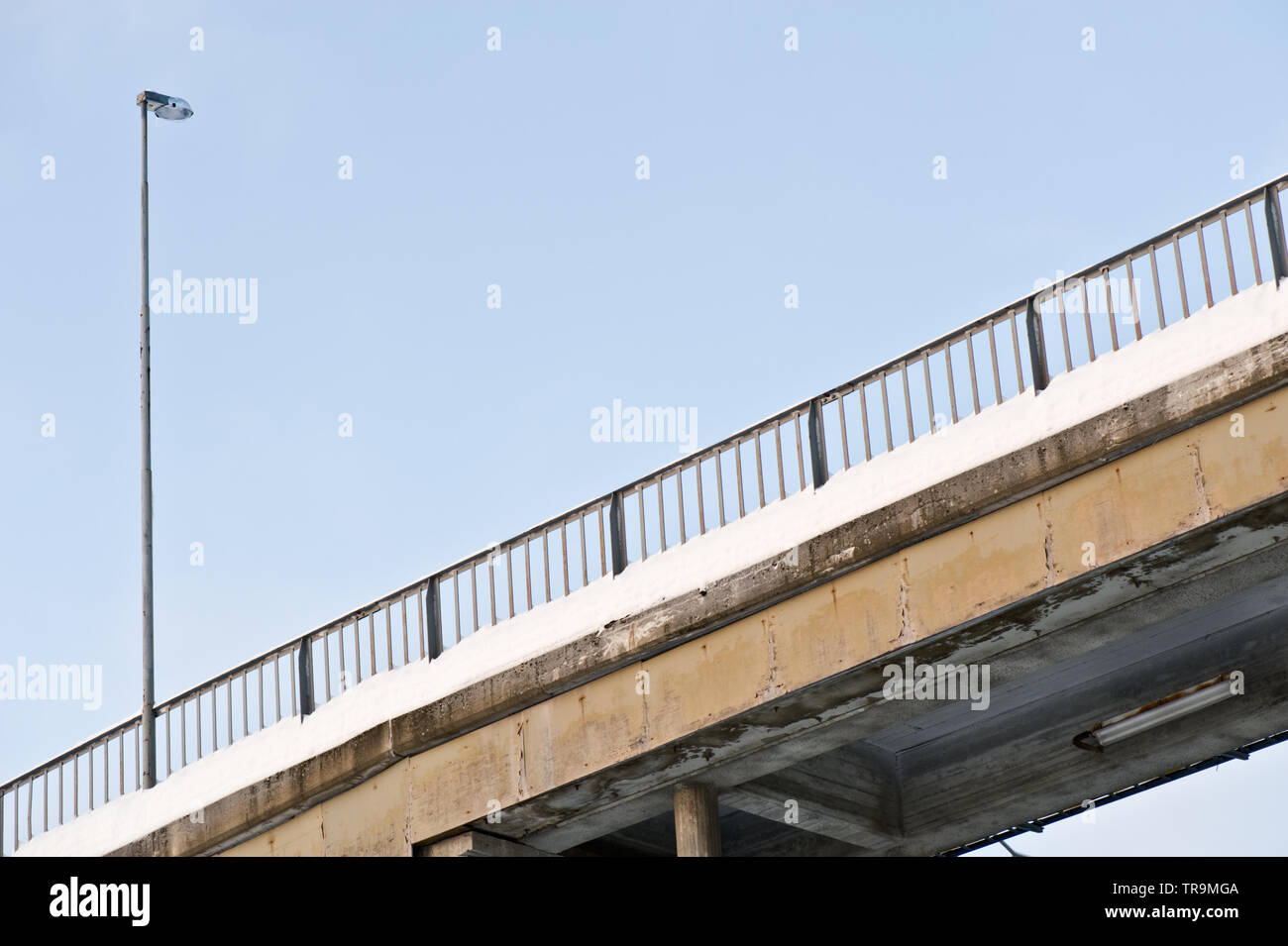 Bridge with railing and street light against blue sky Stock Photo - Alamy