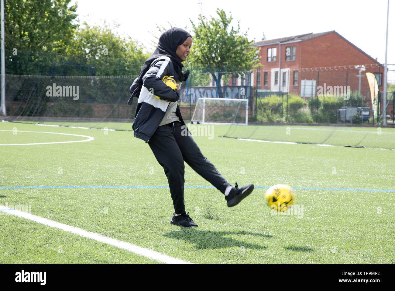 Kicking ball muslim hi-res stock photography and images - Alamy