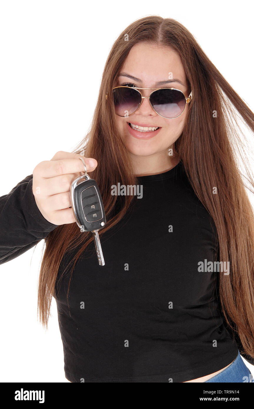 A young teenage girl got the keys for her new car holding them up ...