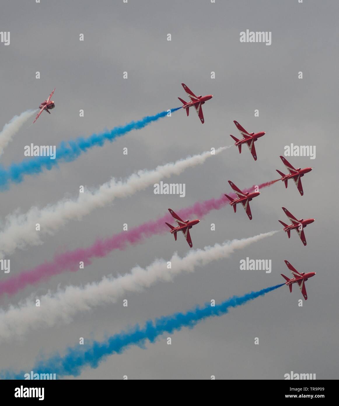 Red Arrows display with red, white and blue smoke Stock Photo - Alamy