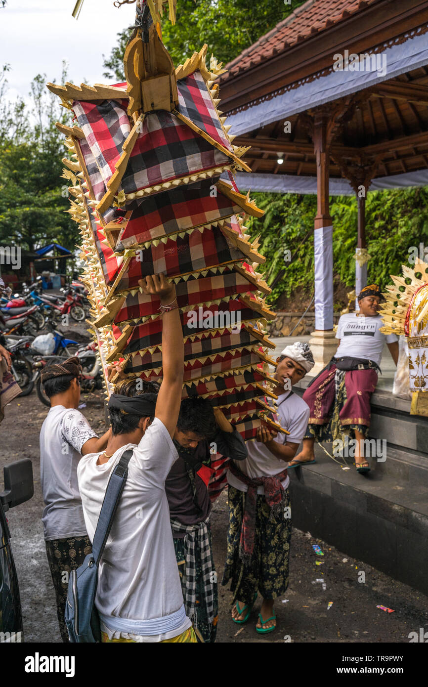 Balinese men preparing temple for religious festival Galungan and ...