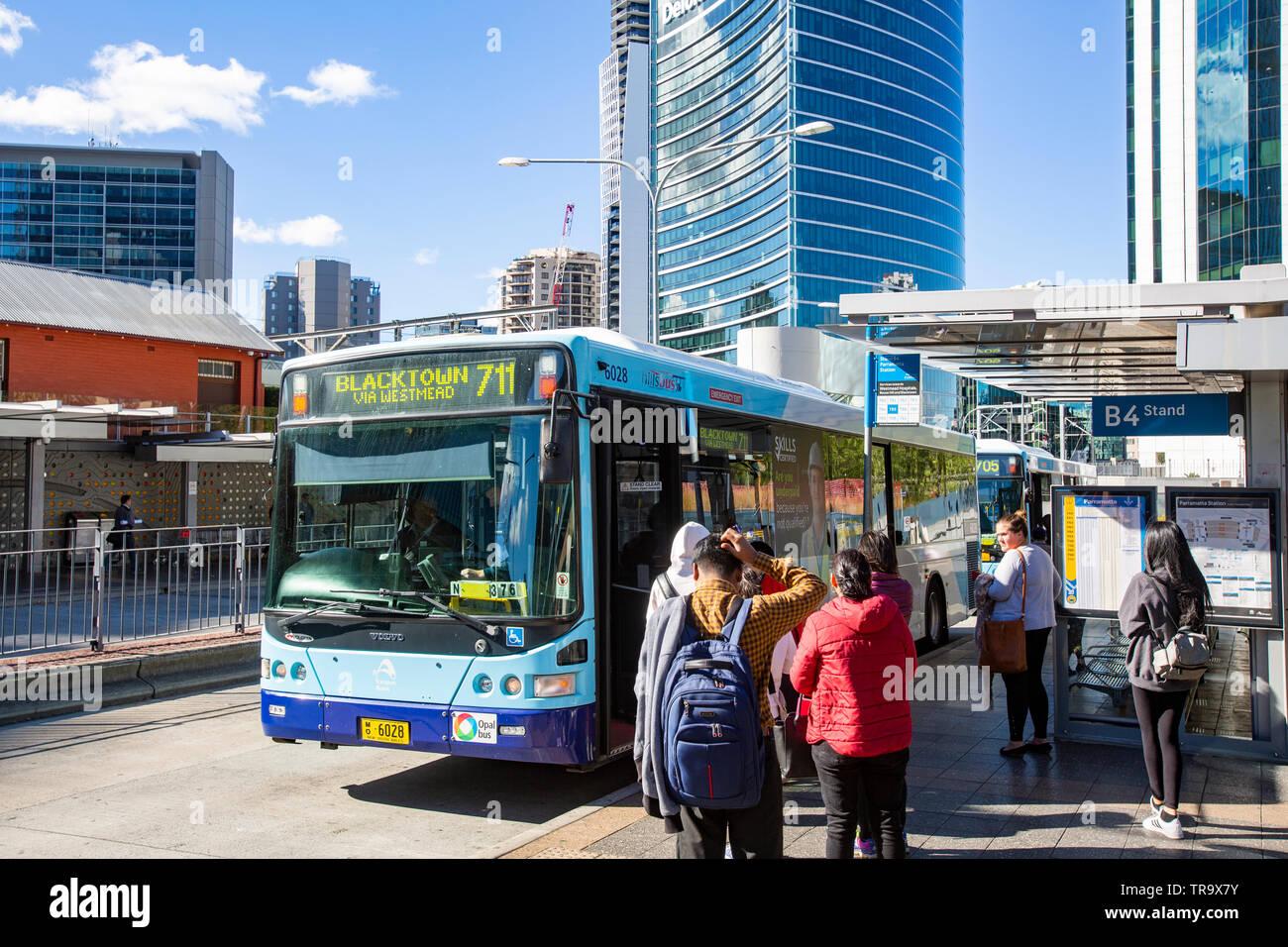 Sydney bus and passengers at Parramatta transport interchange bus stop ...