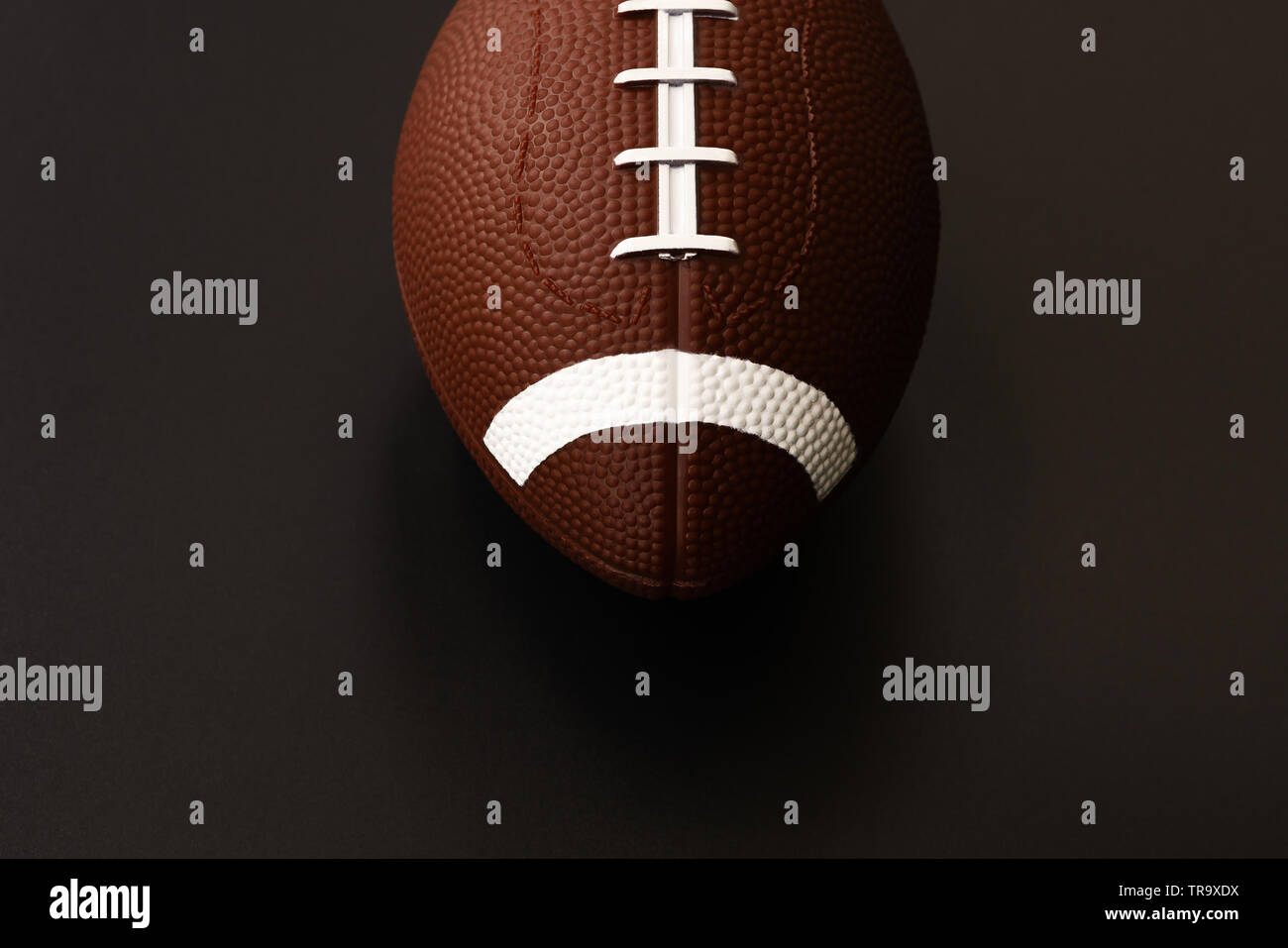 American football isolated on black background . Sport object concept ...