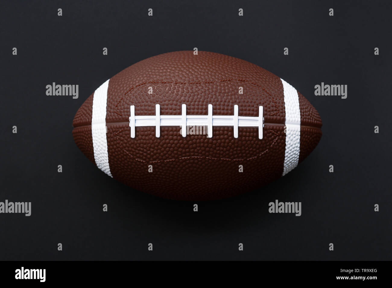 American football isolated on black background . Sport object concept ...