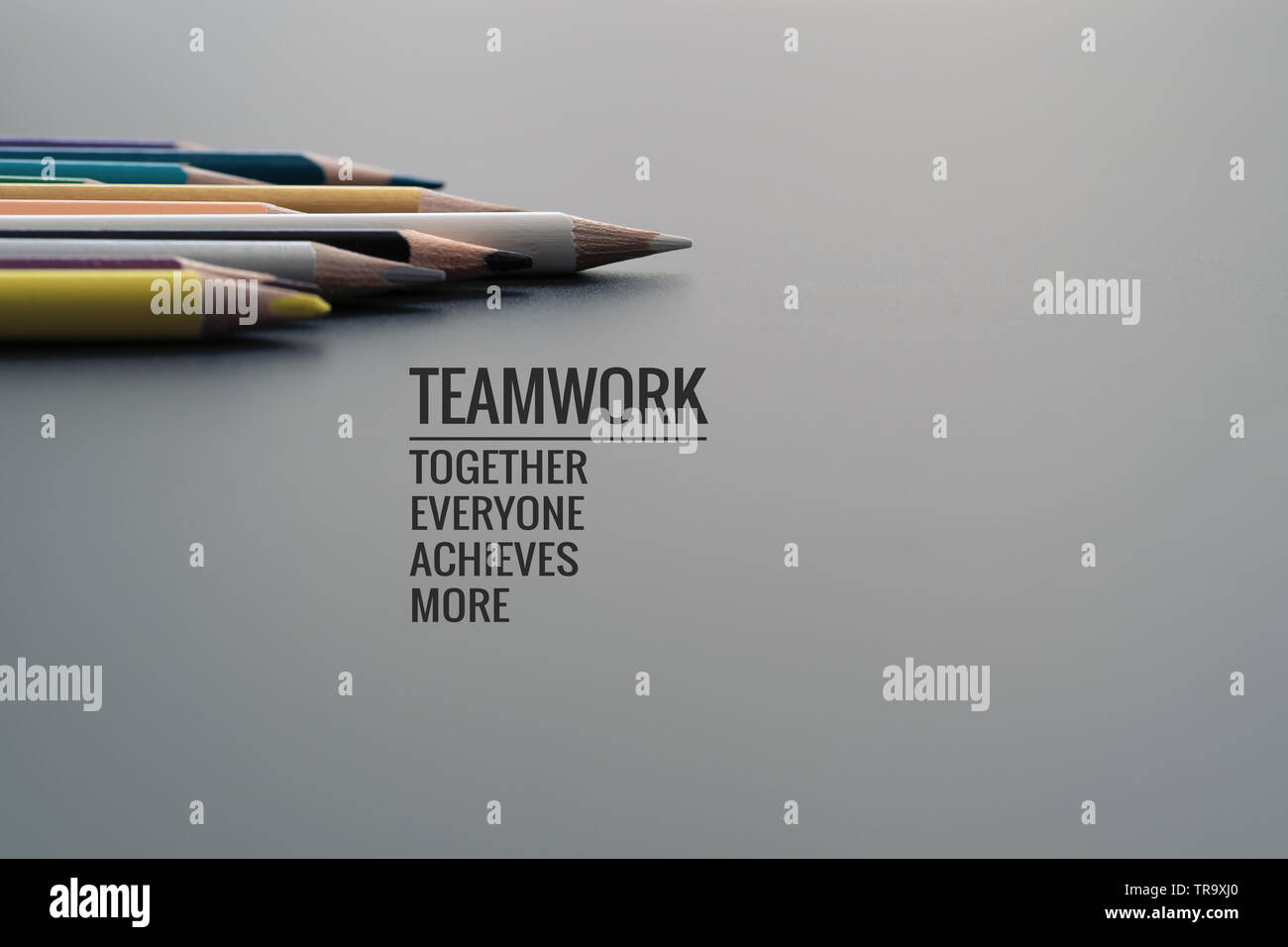Teamwork concept. group of color pencil on black background with word ...