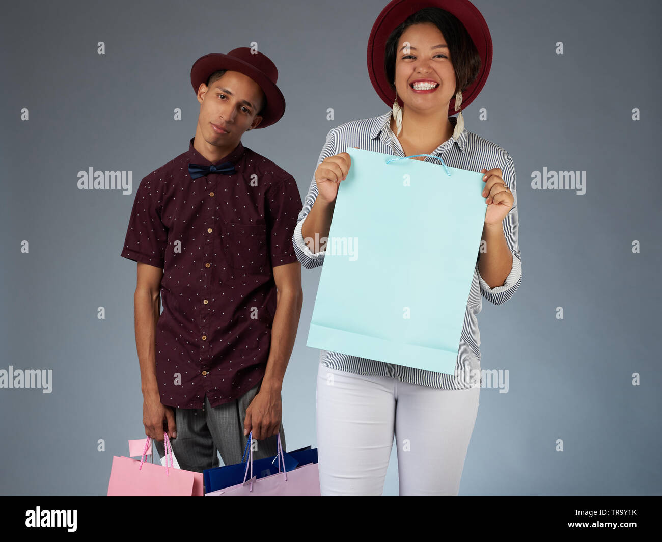Smiling woman and sad man in shopping theme Stock Photo - Alamy