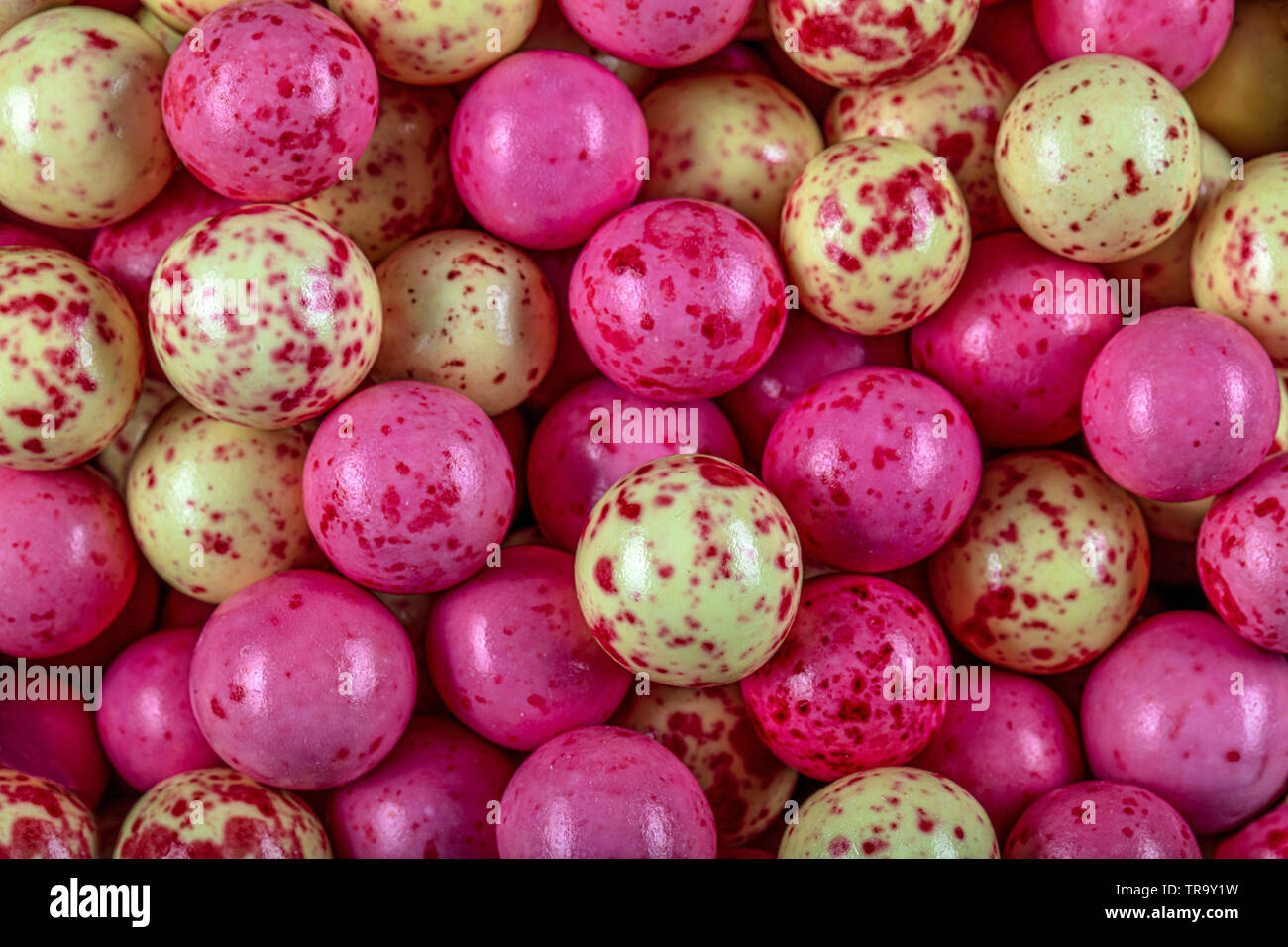 Roasted chickpeas covered in chocolate, fruit sauce. colorful candies ...