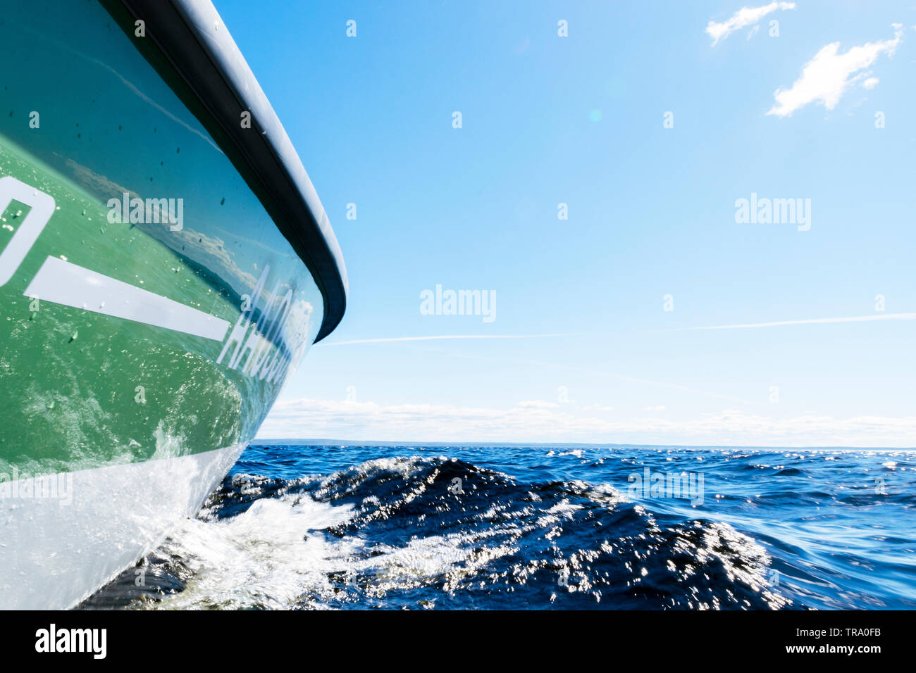 Speeding fishing motor boat with drops of water. Blue ocean sea water ...