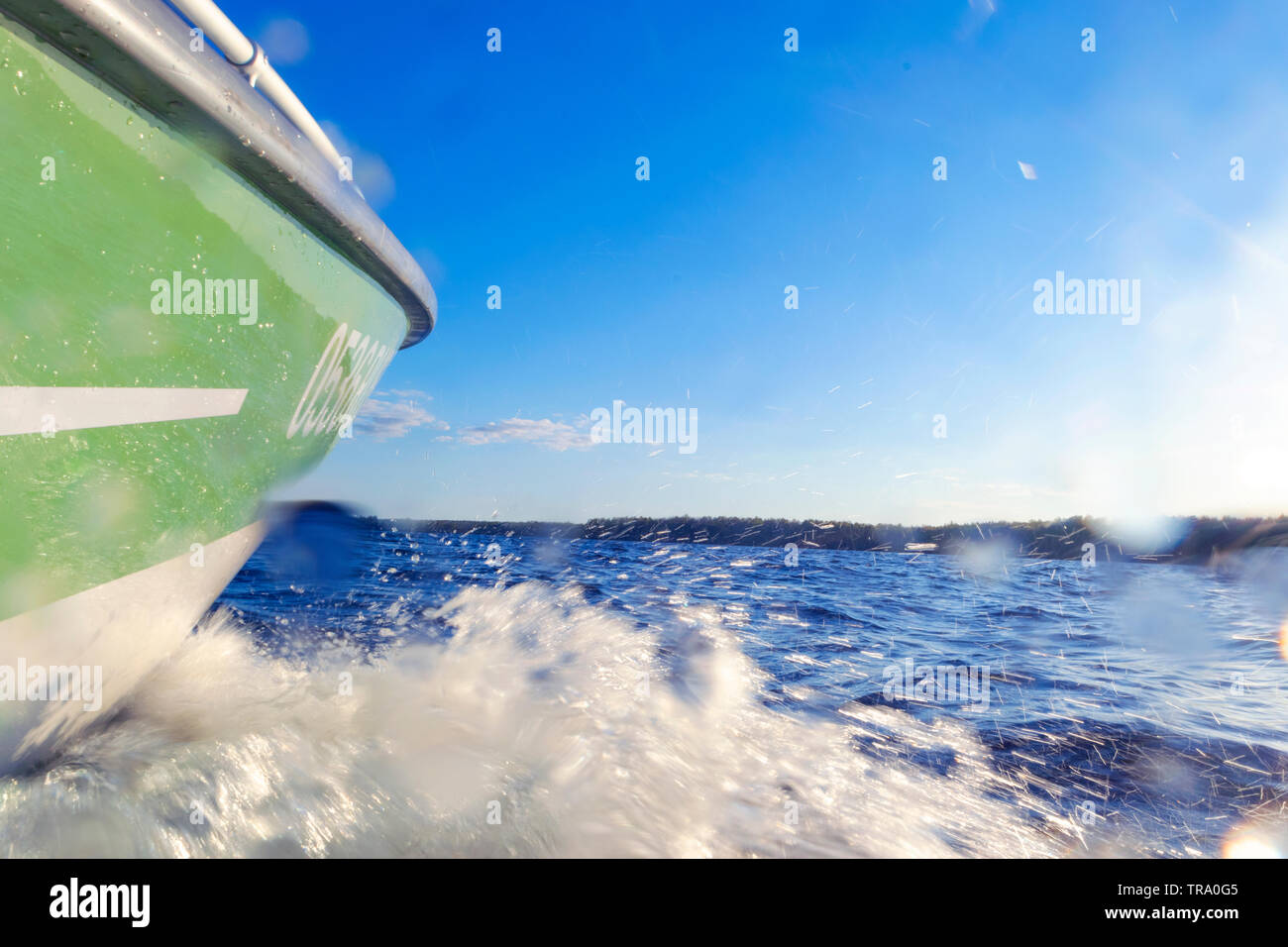 Speeding fishing motor boat with drops of water. Blue ocean sea water ...