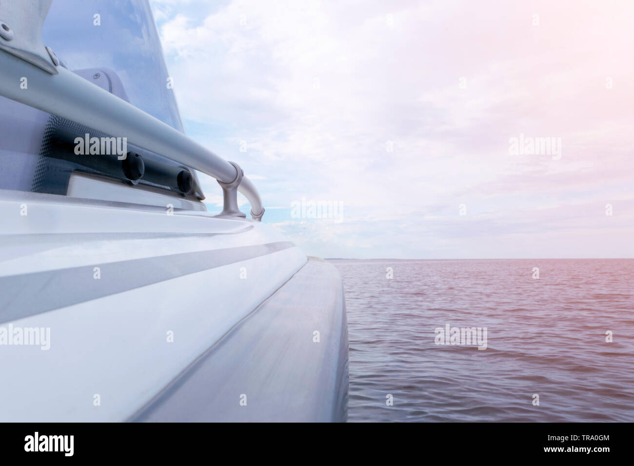 Side view Speeding fishing motor boat with drops of water. Blue ocean ...