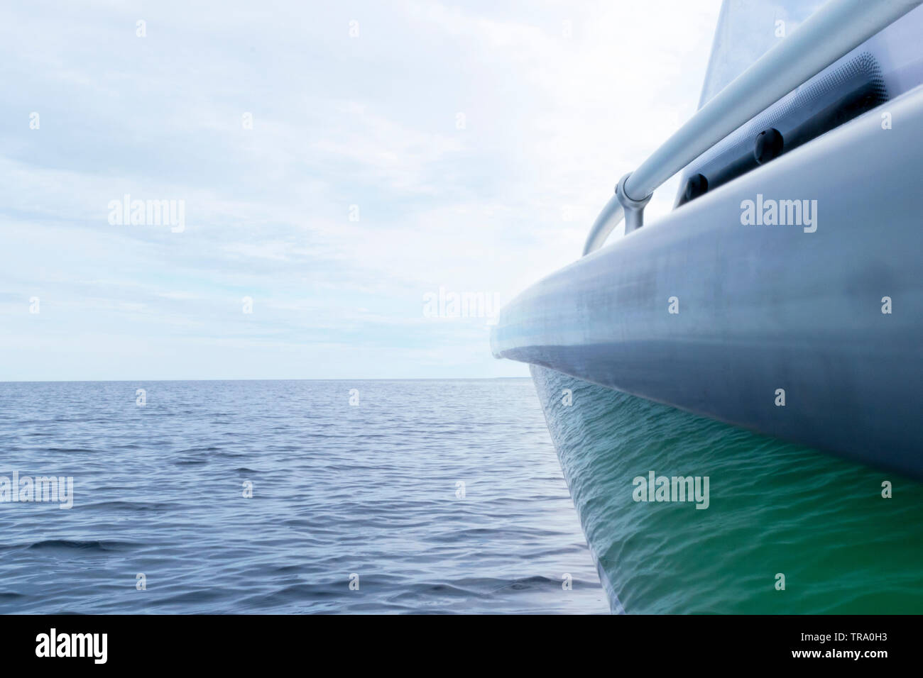 Side view Speeding fishing motor boat with drops of water. Blue ocean ...