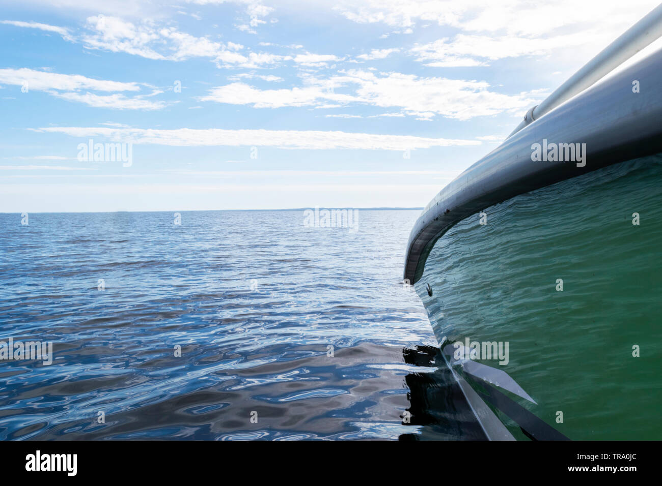 Side view Speeding fishing motor boat with drops of water. Blue ocean ...