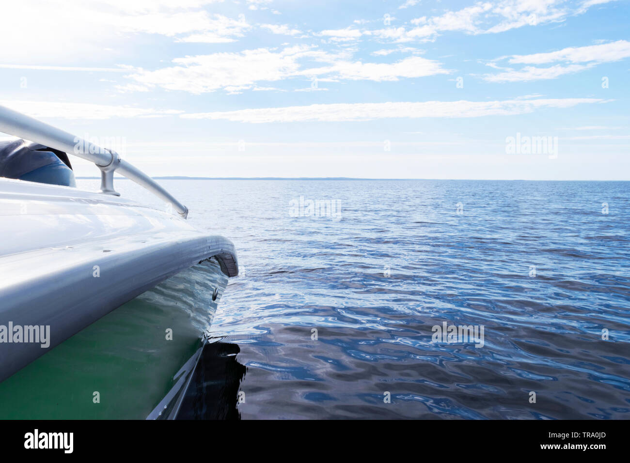 Side view Speeding fishing motor boat with drops of water. Blue ocean ...