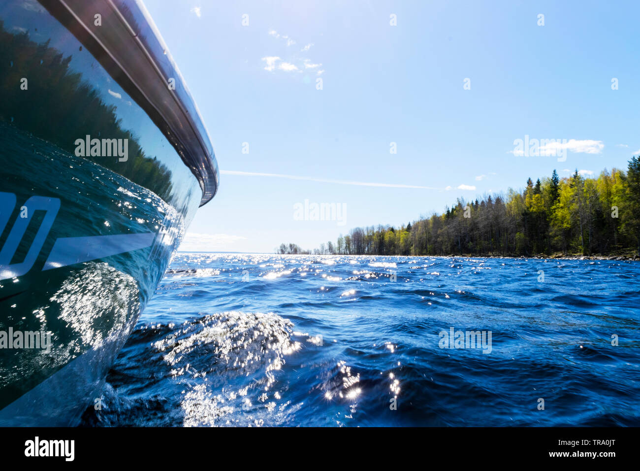 Side view Speeding fishing motor boat with drops of water. Blue ocean ...