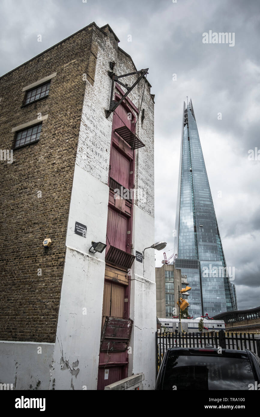 An old warehouse in South East London with the Shard skyscraper in the ...