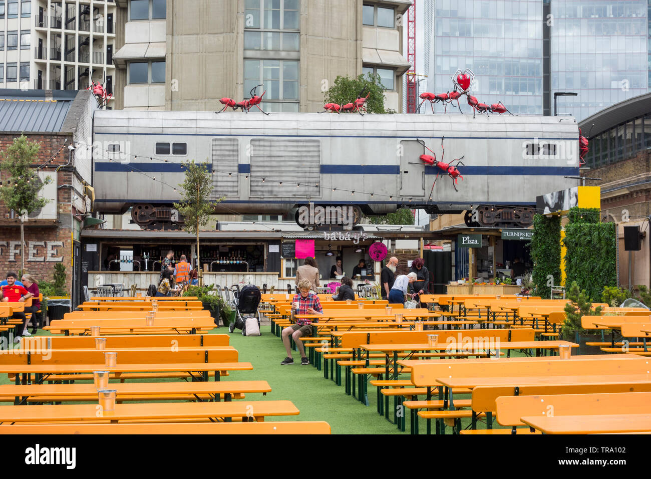 Train carriage and giant red ants installation at Vinegar Yard, St ...