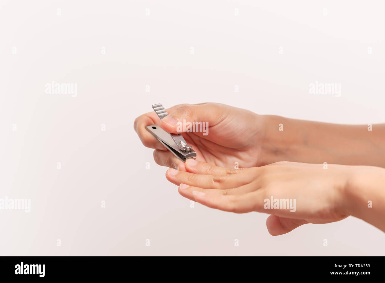 woman hand cutting nails using nail clipper on white backgrounds Stock ...