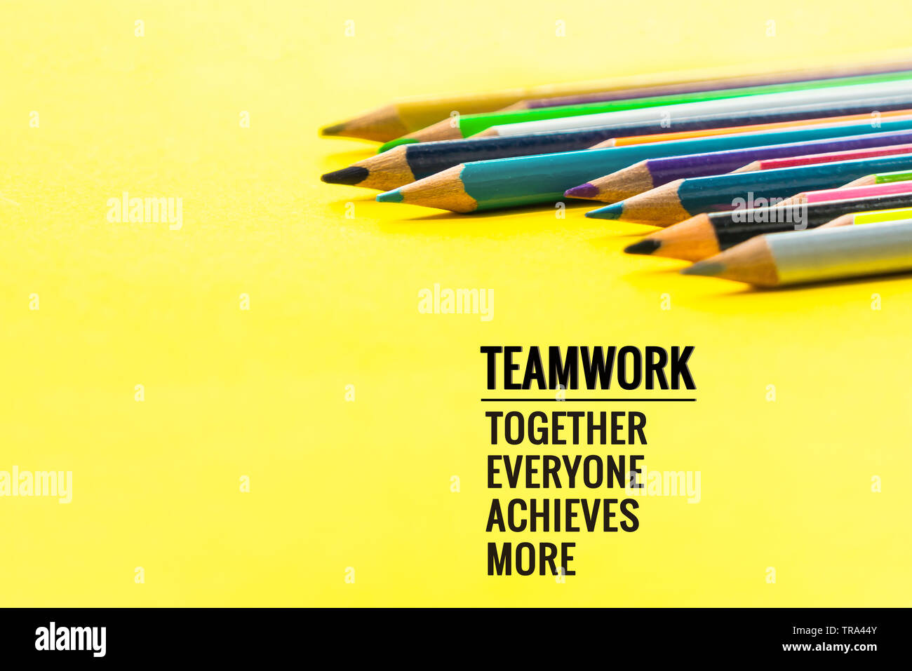 Teamwork concept. group of color pencil on yellow background with word ...