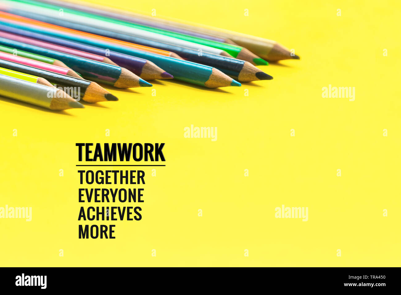 Teamwork concept. group of color pencil on yellow background with word ...