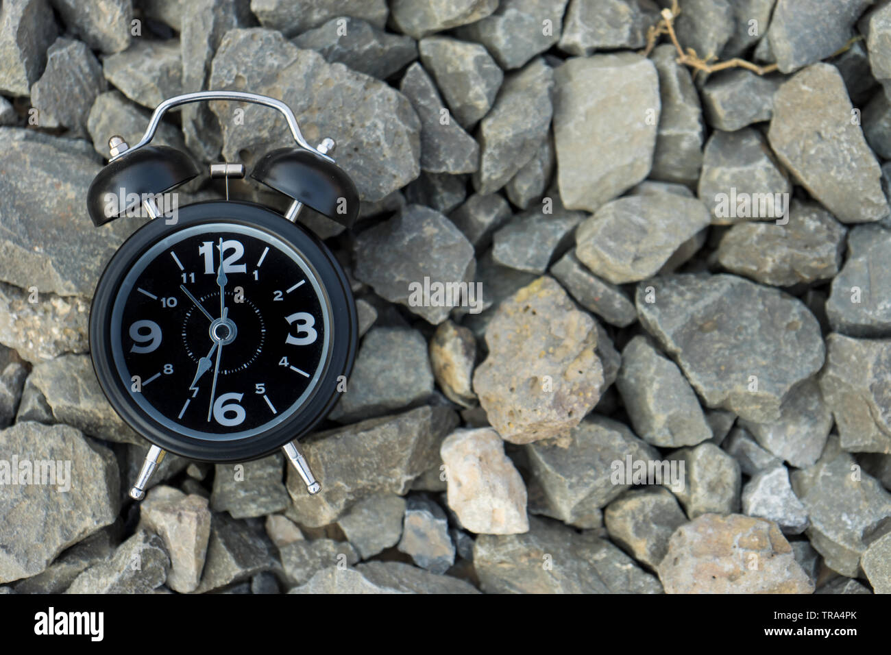 black alarm clock on stone background Stock Photo - Alamy