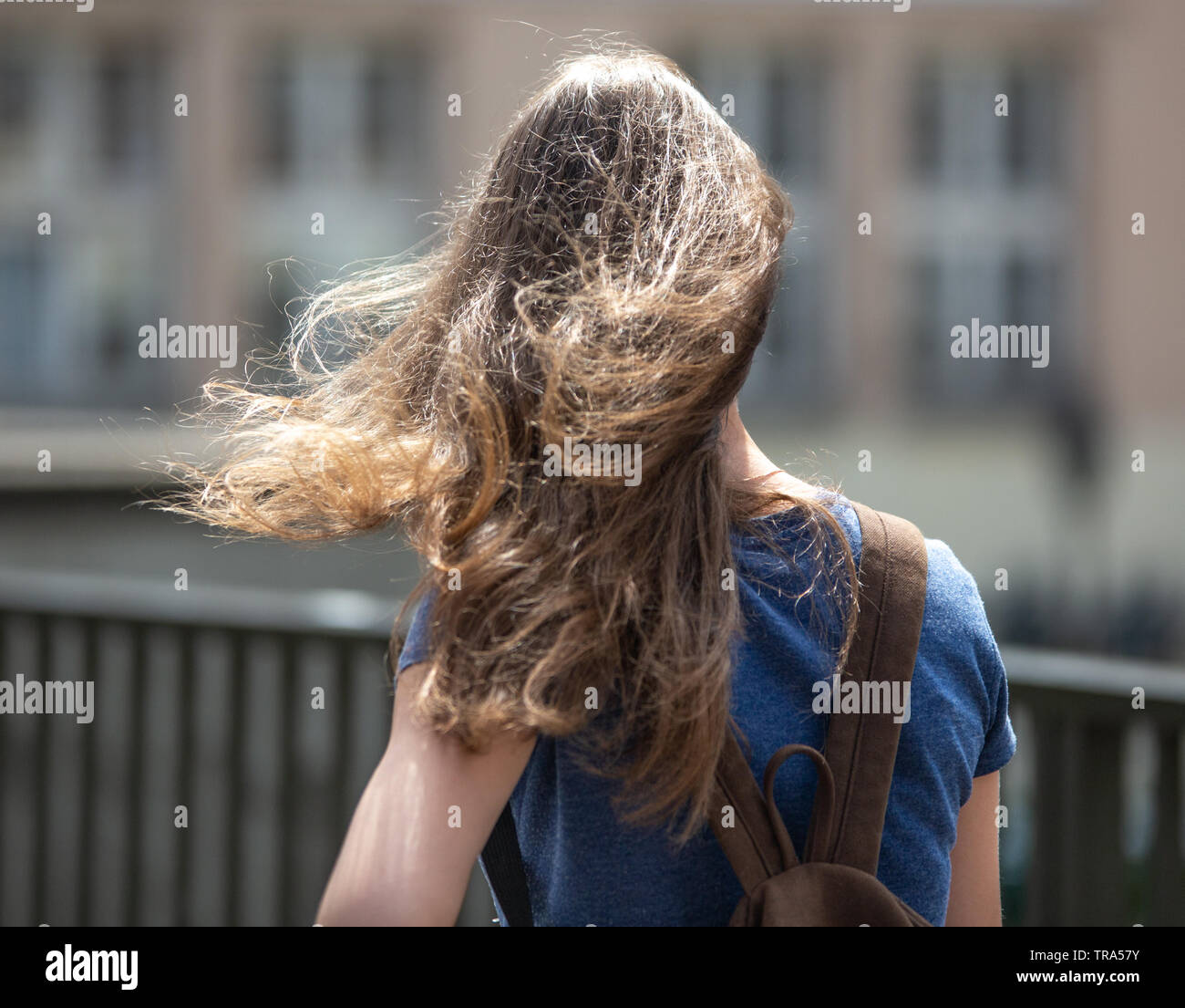Long hair on the strong wind. arranging naughty hair Stock Photo - Alamy