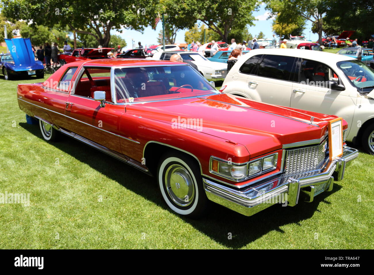 A red Cadillac DeVille amongst vintage vehicles and Hot Rods at a ...