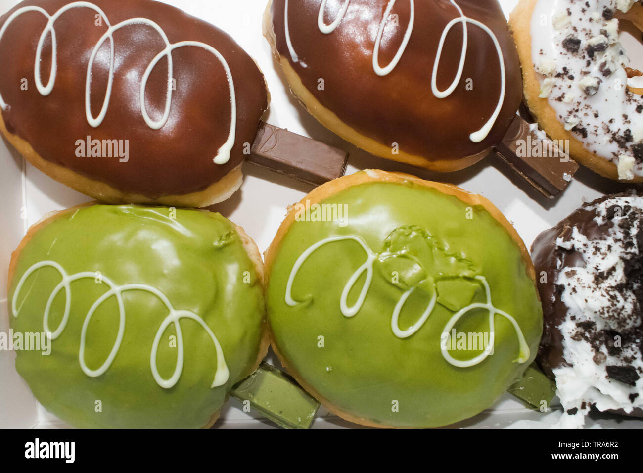 Green and Brown coloured doughnuts Stock Photo - Alamy