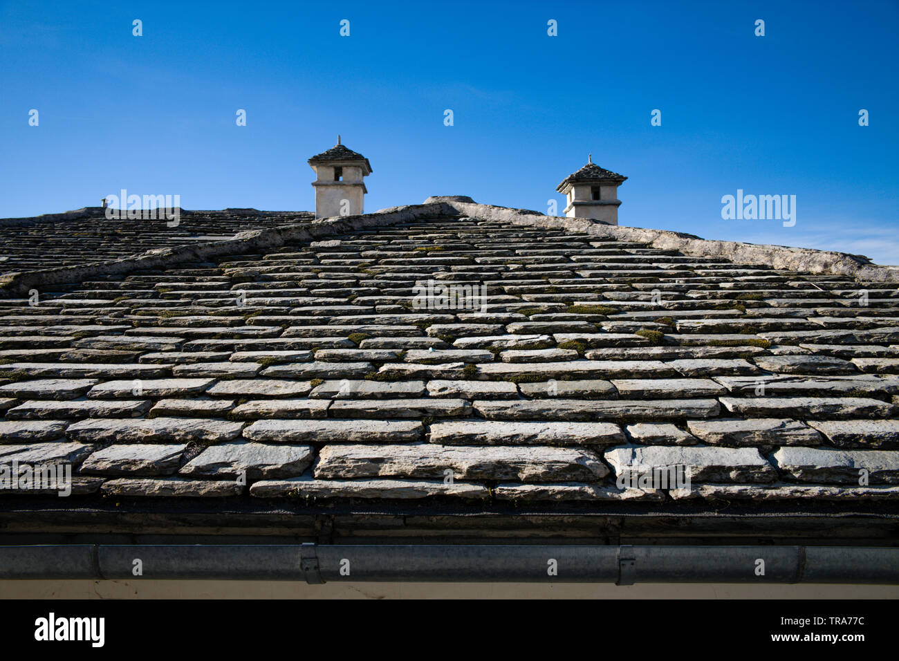 Stone roof with two chimneys, Markinitsa Greece Stock Photo - Alamy