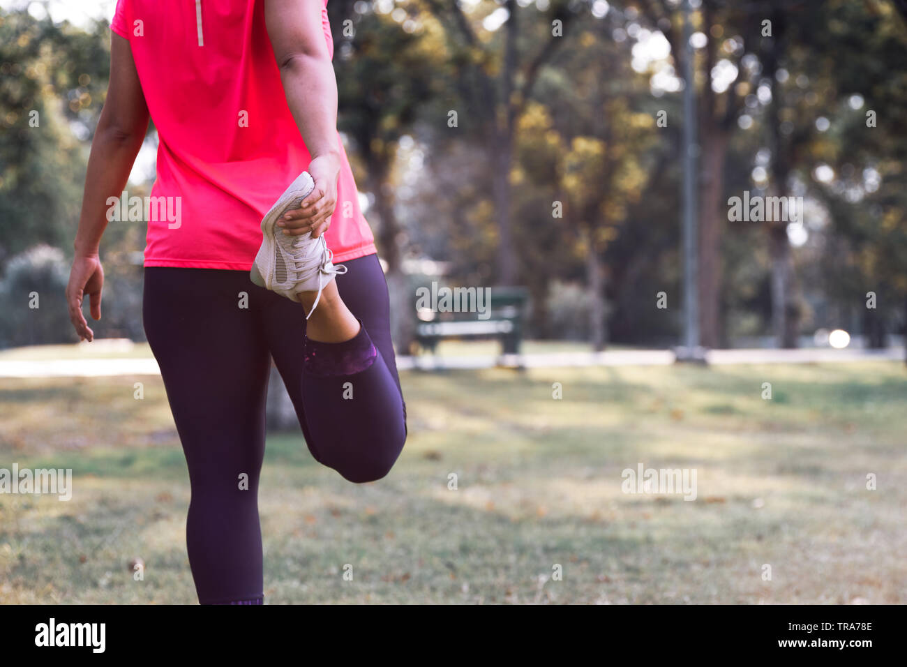 Sport woman stretching leg muscle preparing for running in the public ...