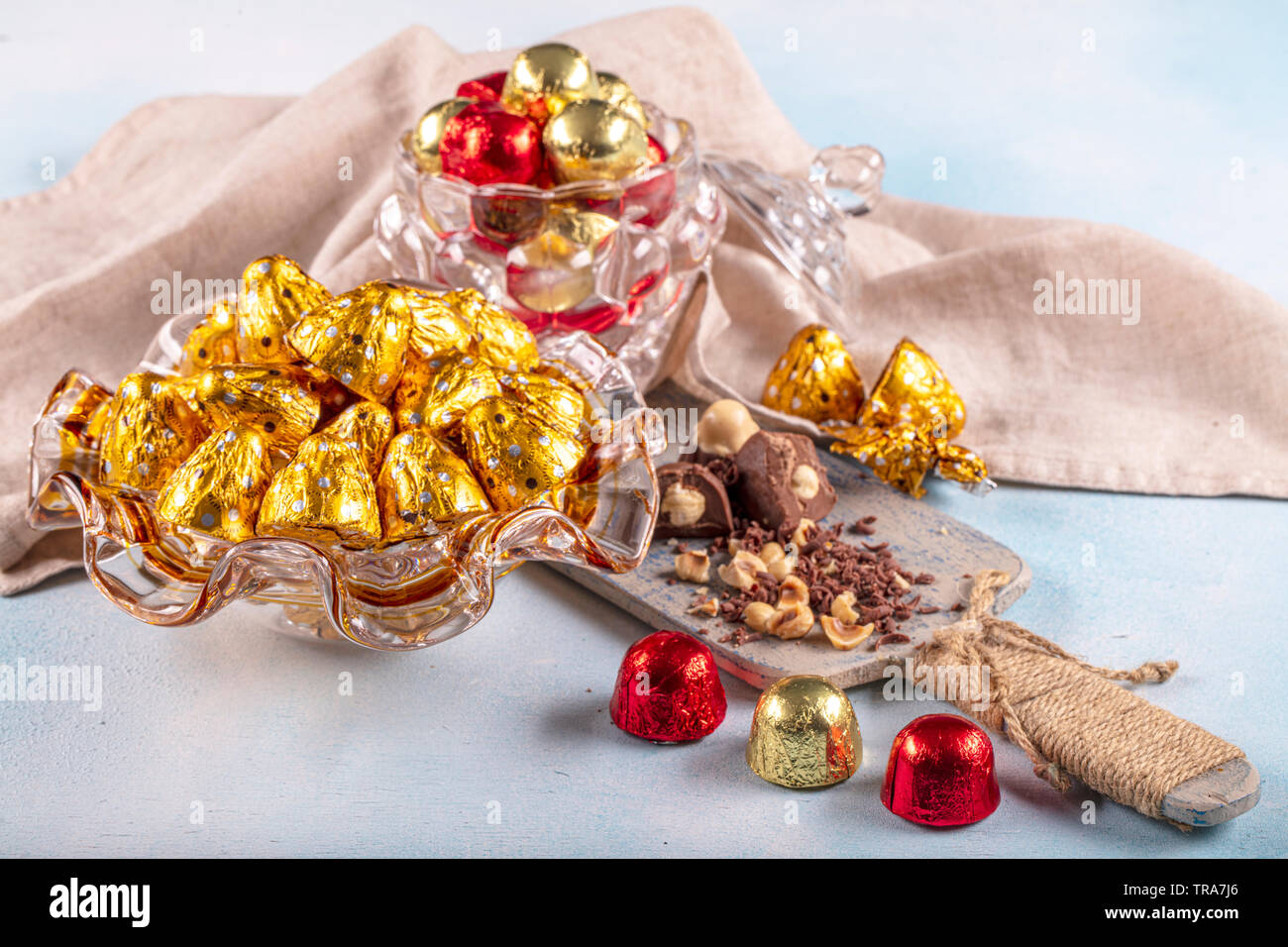 Chocolate candy in shiny wrapper. Delicious chocolate candies on wooden ...