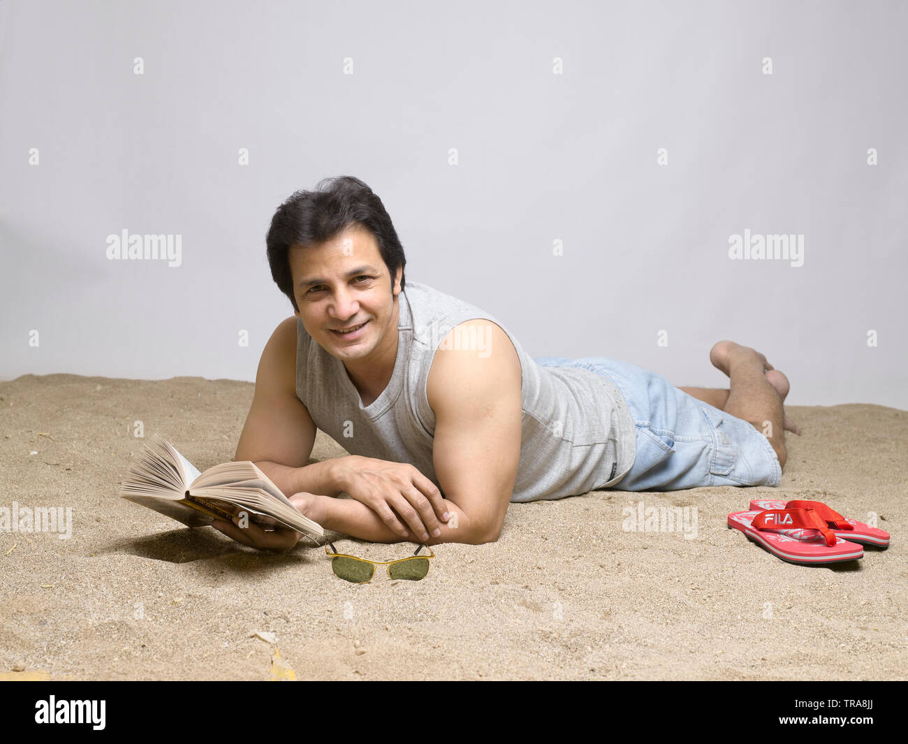 Happy young guy reading hi-res stock photography and images - Alamy