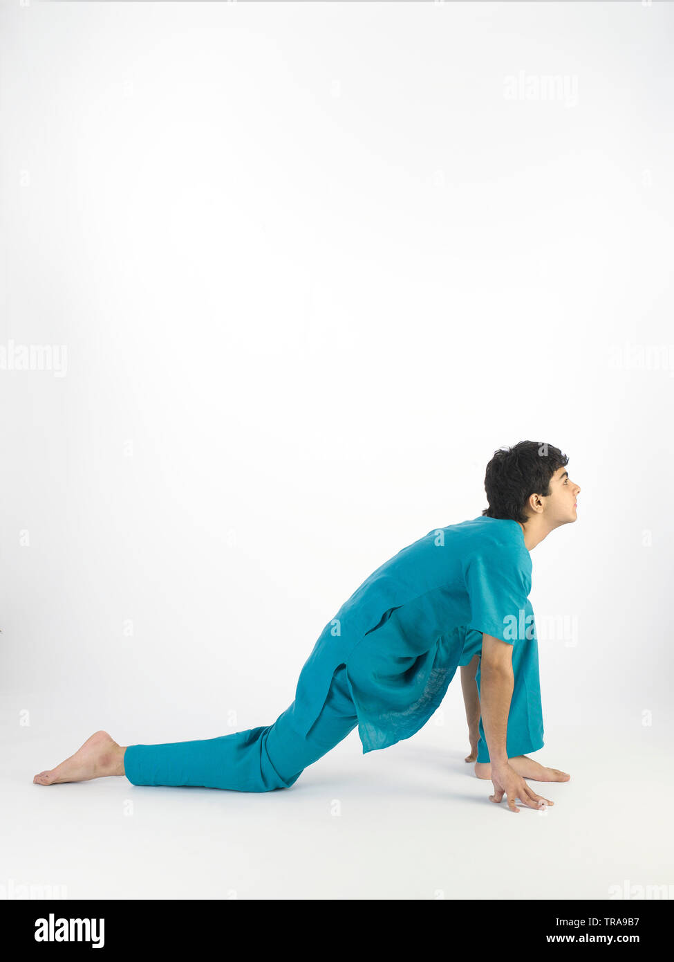 PORTRAIT OF A YOUNG BOY PERFORMING THE SURYA NAMASKAR POSE #4 CALLED ...