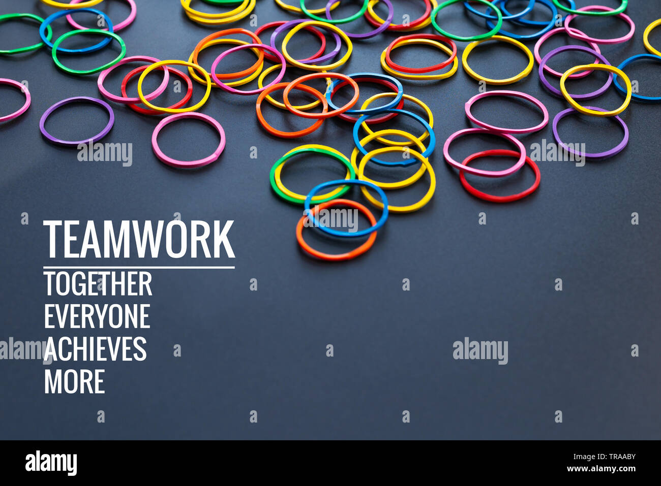 Teamwork concept. group of colorful rubber band on black background ...