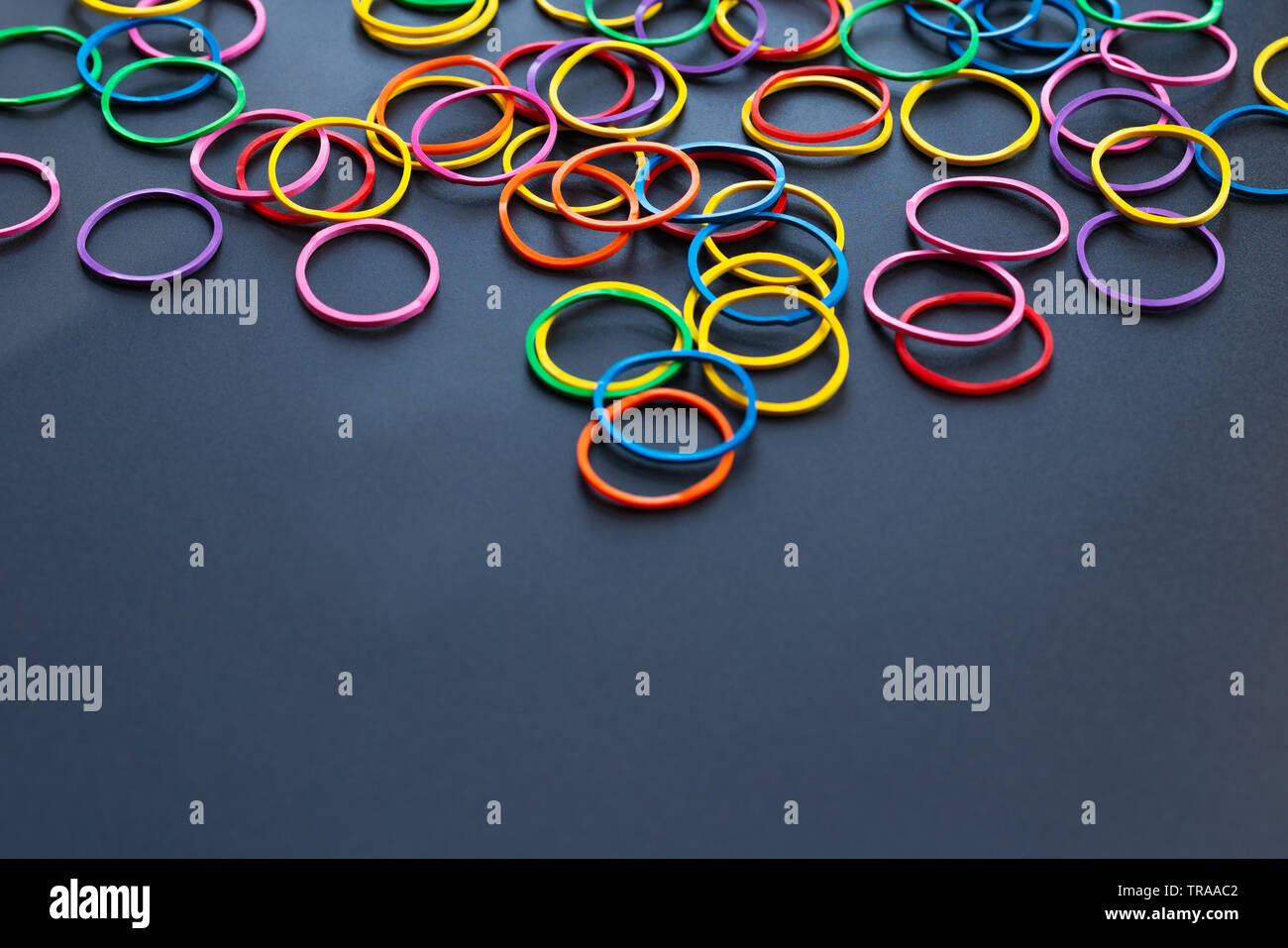 Teamwork concept. group of colorful rubber band on black background ...