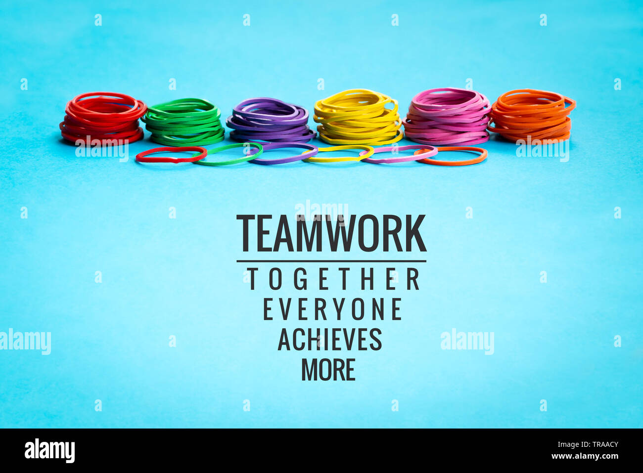 Teamwork concept. group of colorful rubber band on blue background with ...