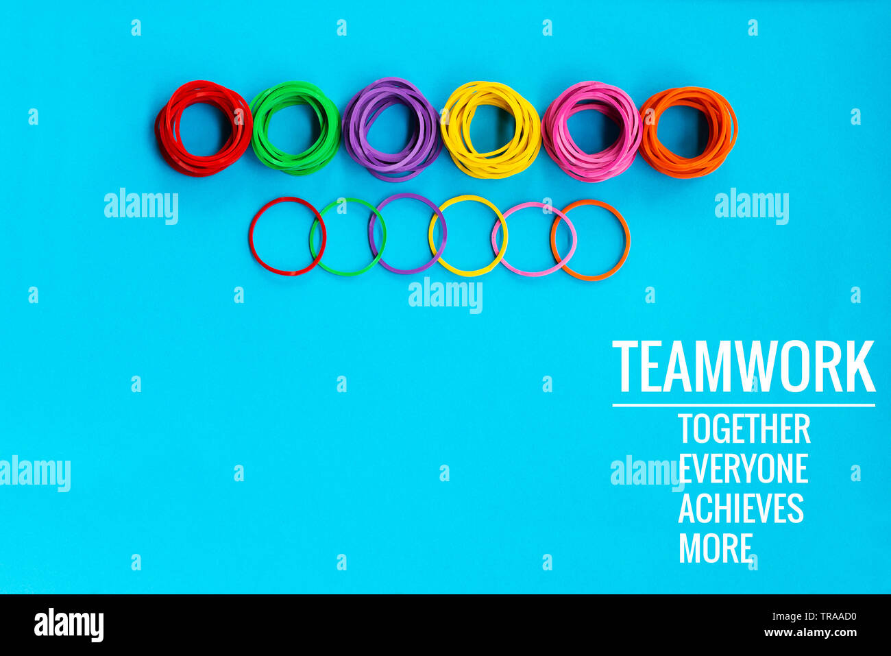 Teamwork concept. group of colorful rubber band on blue background with ...