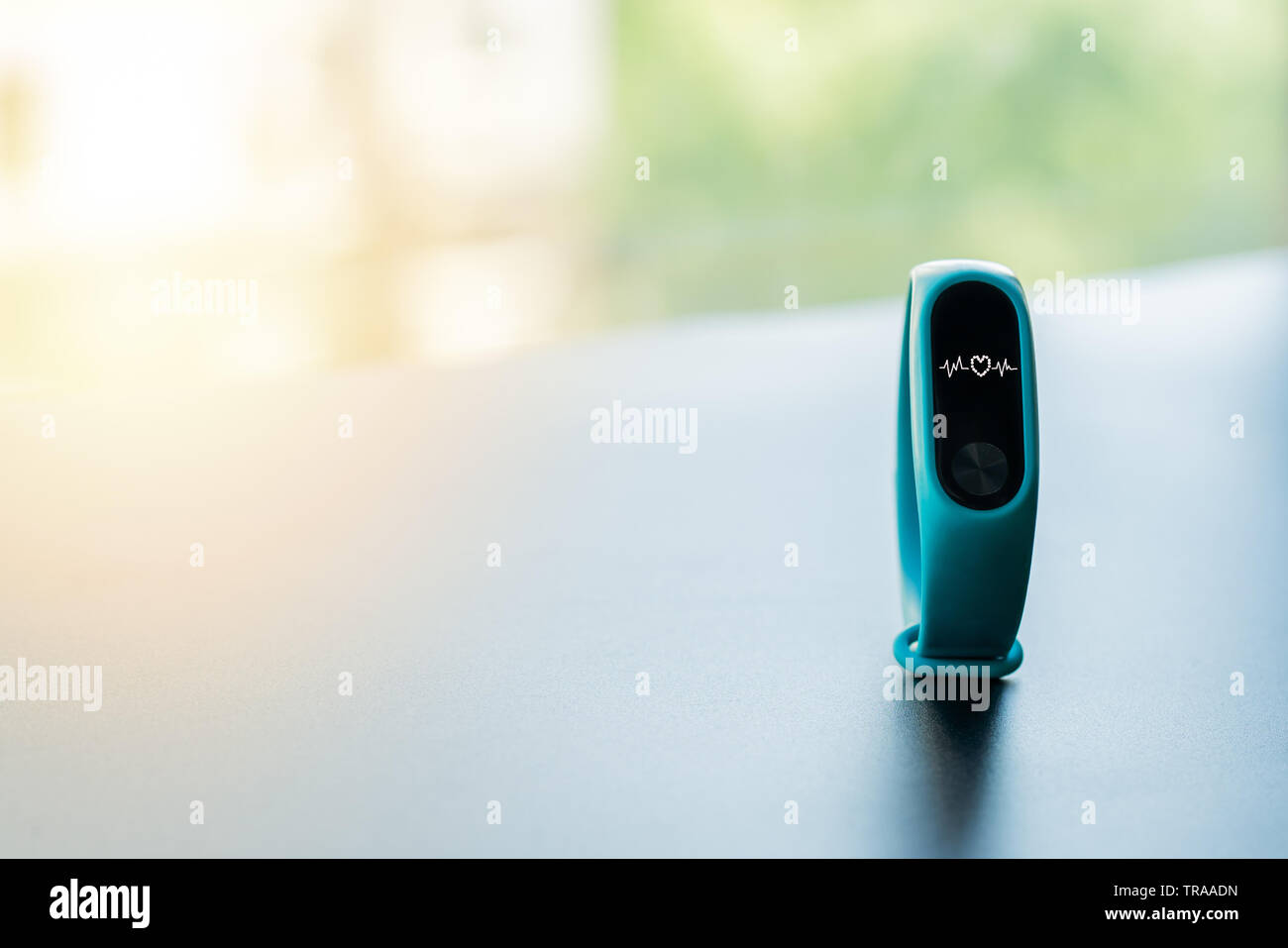 fitness smart band device blue color on black background with heart ...