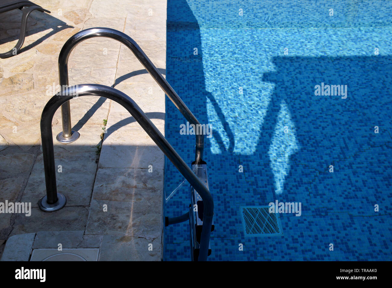 Handrail on pool. Swimming pool with stair at tropical resort. Pool ...
