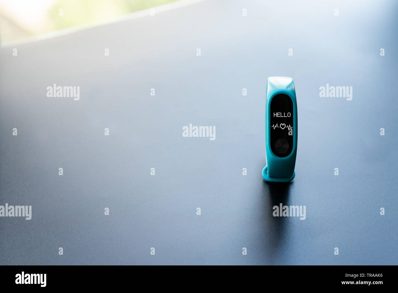 fitness smart band device blue color on black background with word ...