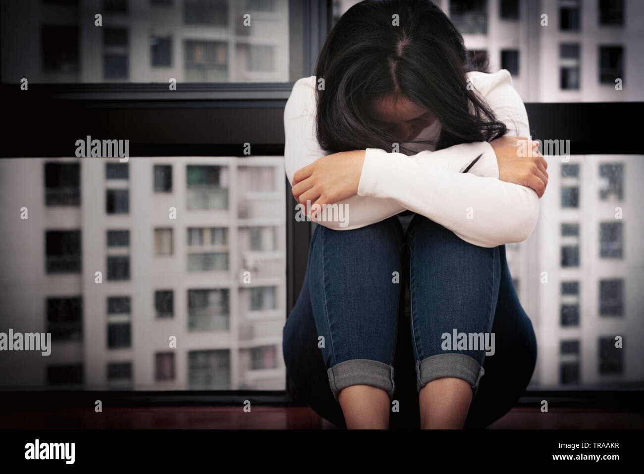 depressed women sitting near window, alone, sadness, emotional concept ...