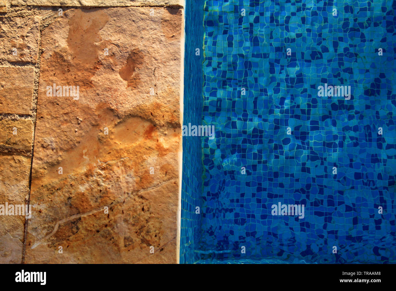 Blue ripped water in swimming pool in tropical resort with edge of ...