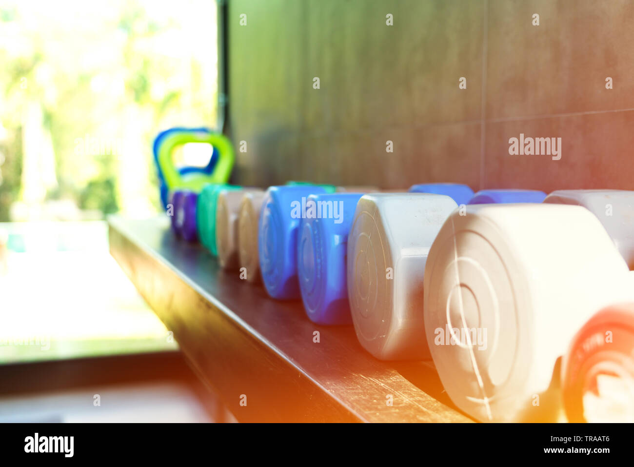 colorful dumbbell row in fitness gym for musclebuilding Stock Photo - Alamy