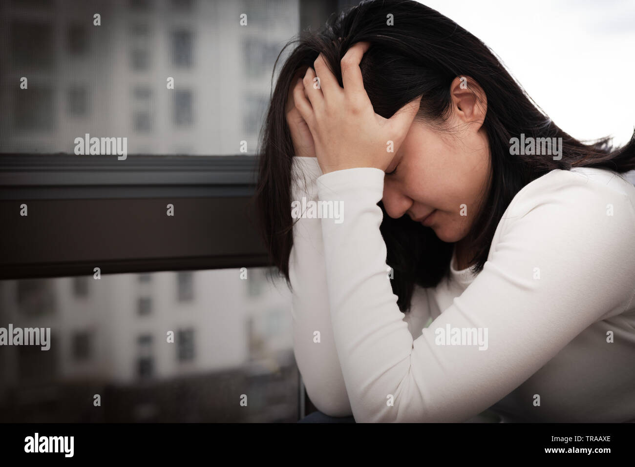 depressed women sitting near window, alone, sadness, emotional concept ...