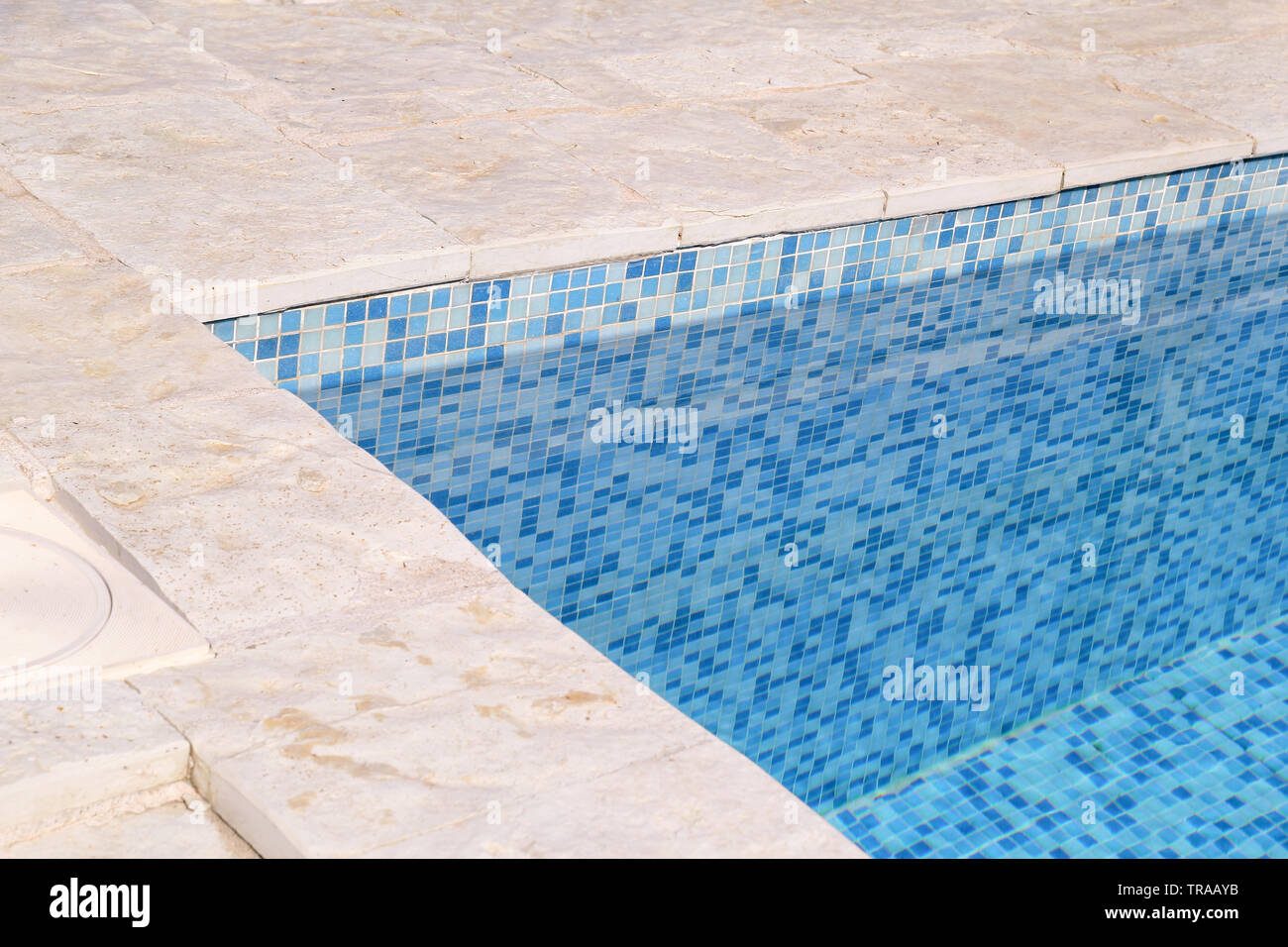 Blue ripped water in swimming pool in tropical resort with edge of ...