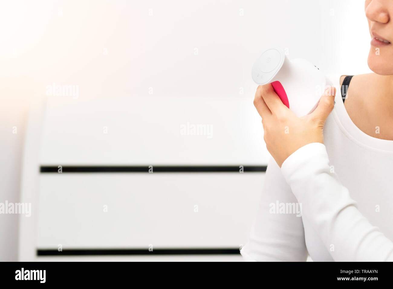 electric arm, neck and shoulder massage machine on women shoulder ...